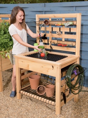 It should have ample storage space for potting soil, pots, and tools.